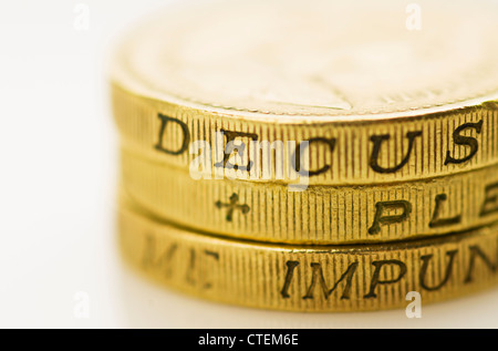 Close up of three pound coins in a stack on a page from the Financial ...