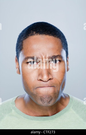 Studio shot of angry young man doctor wearing protective glasses while ...