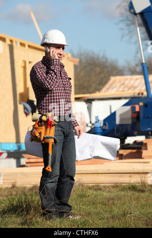 Construction worker and foreman discussing roof beams Stock Photo - Alamy