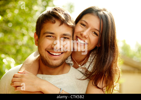 Portrait of a happy couple laughing at camera. Bridesmaid and groomsmen ...