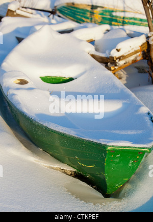 Lone moored boat covered in snow in small lake inlet Stock Photo - Alamy