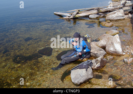 diver prepares to diving in Baikal lake, Siberia, Russian Federation ...