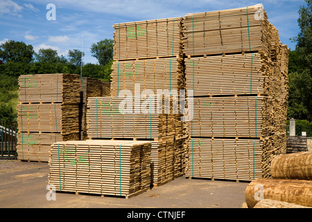 Timber planks stacked in large industrial wood shed with side loader ...