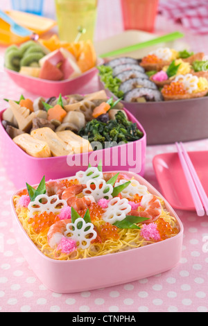 A Japanese Bento Box filled with sushi, rice, pickles, beef ...