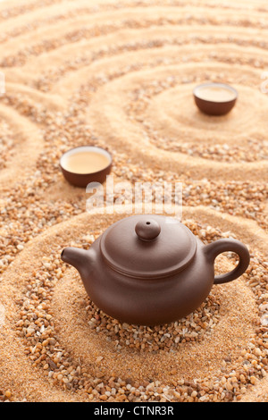 Tea set in sand Stock Photo - Alamy