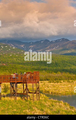 Visitors enjoy view boardwalk at Potter Marsh Anchorage hillside in ...