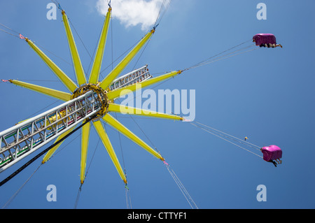 Colorful flying swing ride in motion at the amusement park Stock Photo ...