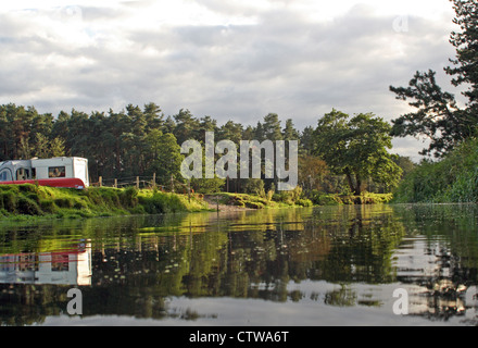 Caravan and canoes in Thetford Forest, beside the Little Ouse River ...