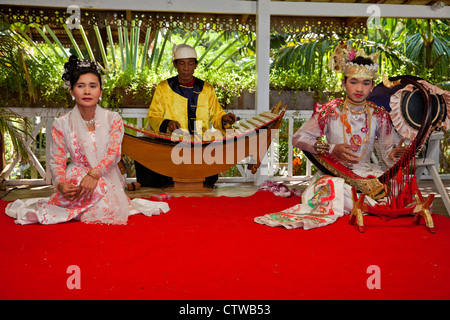 An ensemble of Burmese musicians playing traditional instruments at a ...