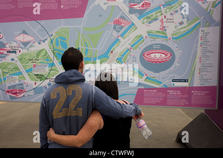 Spectators consult a detailed map of the Olympic Park during the London ...