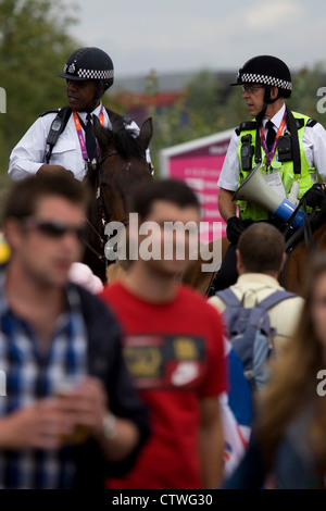 People, including security and police officers, are gathered outside a ...