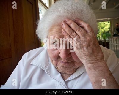 Apprehensive worried vulnerable senior elderly old age lady in her ...