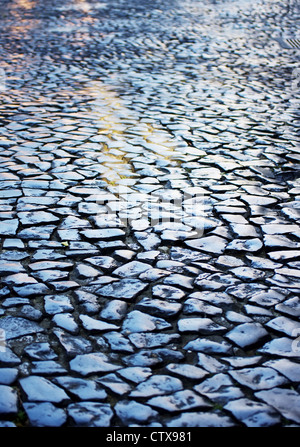 Undulating background of a street paved in red bricks, running bond ...