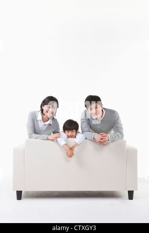 Asian man resting on couch using smartphone while sick at home Stock ...