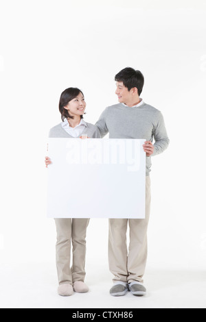 Family paper cut out is standing in a meadow, parents with daughter and ...