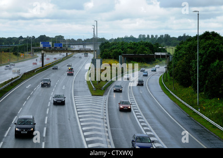 motorway in the wet with old style central reservation barrier before ...