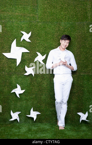 A standing man with white pinwheels Stock Photo - Alamy