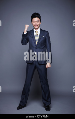 Business man clenching his fist Stock Photo - Alamy