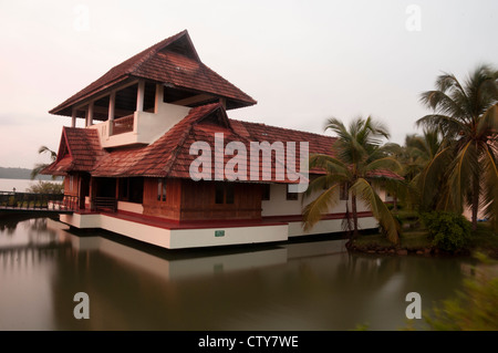 Traditional tile roof house surrounded by greenery of trees and coconut ...