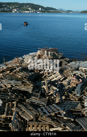 Midsummer Eve bonfire being built out of wooden pallets and crates at ...