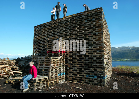 Midsummer Eve bonfire being built out of wooden pallets and crates at ...