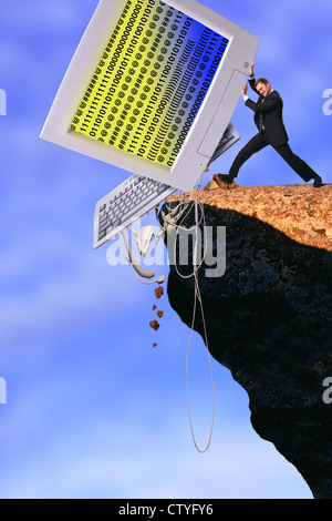 Businessman pushing rock off cliff Stock Photo - Alamy