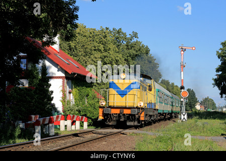 Passenger train starting from the station Stock Photo - Alamy