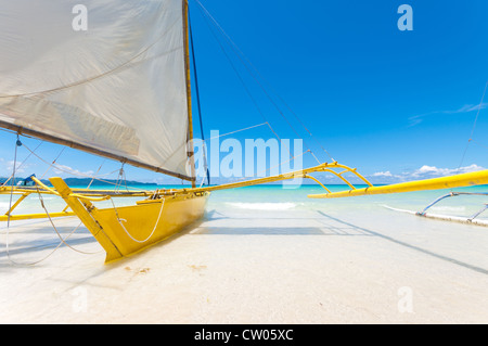traditional paraw sailing boats on white beach on boracay island ...