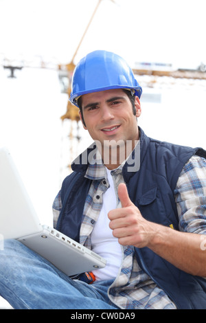 Site engineer giving an ok sign to another engineer during road survey ...