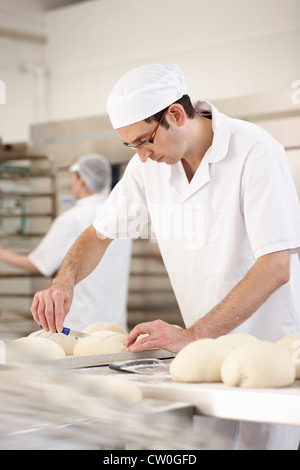 male cook shaping dough for baking bread Stock Photo - Alamy