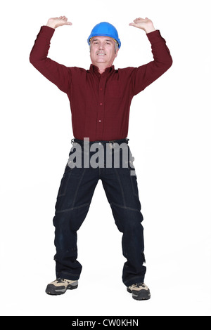 Senior architect pretending to push upwards Stock Photo - Alamy