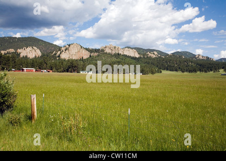 A reef of rocks frame a ranch in the Spanish Peaks Wilderness Area of ...