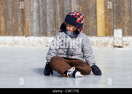 A boy is learning to play ice hockey on the Beishanxi Lake in Jilin ...