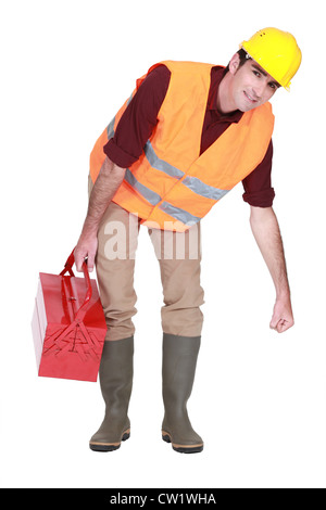 Construction worker lifting something heavy Stock Photo - Alamy