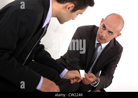 Businessmen exchanging name cards Stock Photo - Alamy