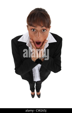 Amazed corporate woman looking to a side isolated on white background ...
