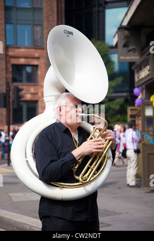 Musician playing a sousaphone in a jazz ensemble providing ...