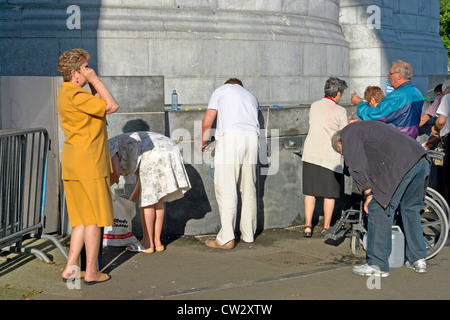 Collecting Lourdes spring water from the Sanctuary of our Lady of ...