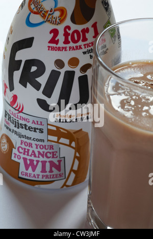 glass of Frijj Fudge Brownie milkshake with bottle set against white ...
