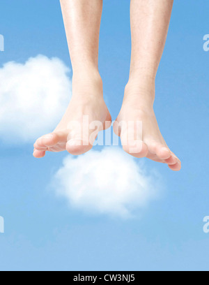 Barefeet in air with blue sky and sun flare Stock Photo - Alamy