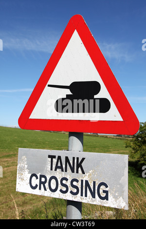 Warning road sign. Tanks crossing and sudden gunfire Stock Photo - Alamy