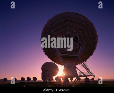 Silhouetted field of VLA Very Large Array radio telescope dishes Stock ...