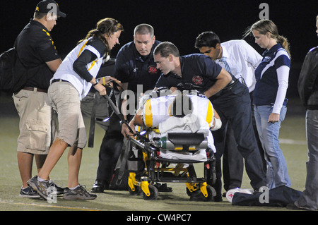 Injured football player on a stretcher Stock Photo - Alamy