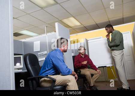 Businessmen in conversation using chart board in an office Stock Photo ...