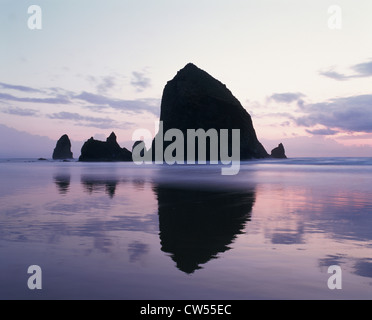 USA, Oregon, Silhouette of Haystack Rock at Cannon Beach at sunset ...