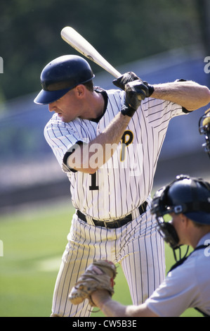 Young hispanic man playing baseball holding bat approving doing ...