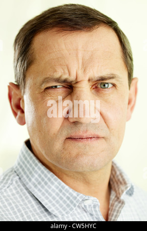 Displeased handsome man posing and looking at camera isolated over ...