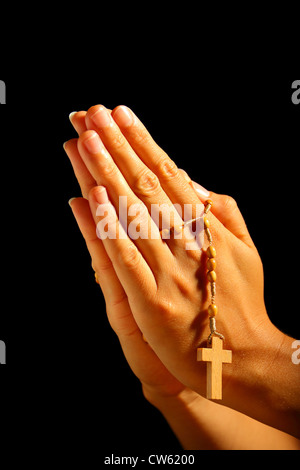 Rosary in hand, prayer. Light through the palms of your hands in ...