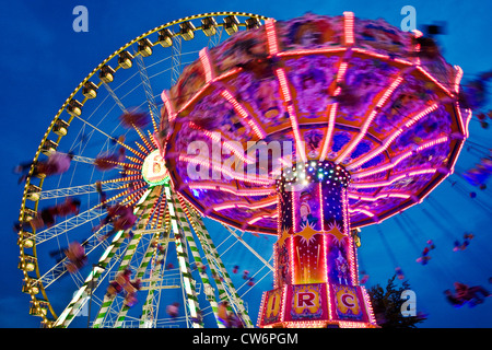 Chain carousel in the evening at the fair Stock Photo - Alamy