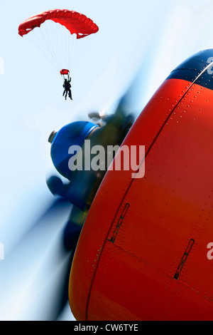 One Sky Diver skydiving with a Red and White Parachute in a Blue Sky ...